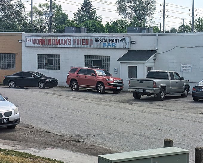 The unassuming exterior of The Workingman's Friend stands as a beacon to burger pilgrims, its vintage sign promising honest food and cold drinks.