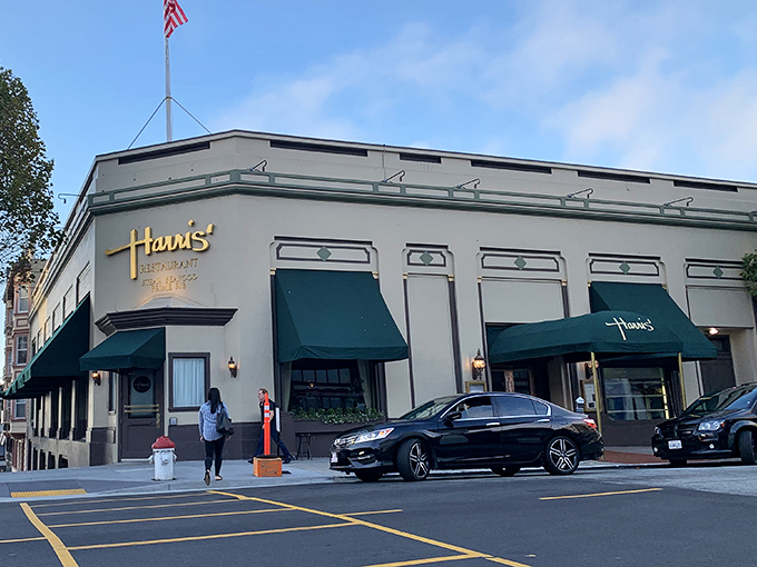 The classic cream exterior with forest green awnings says "serious steak business happens here" before you even walk through the door.