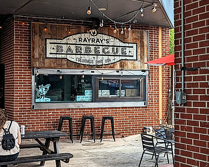 The wooden sign says "barbecue" but what it really means is "prepare for a religious experience." Simple brick exterior, extraordinary flavors within.