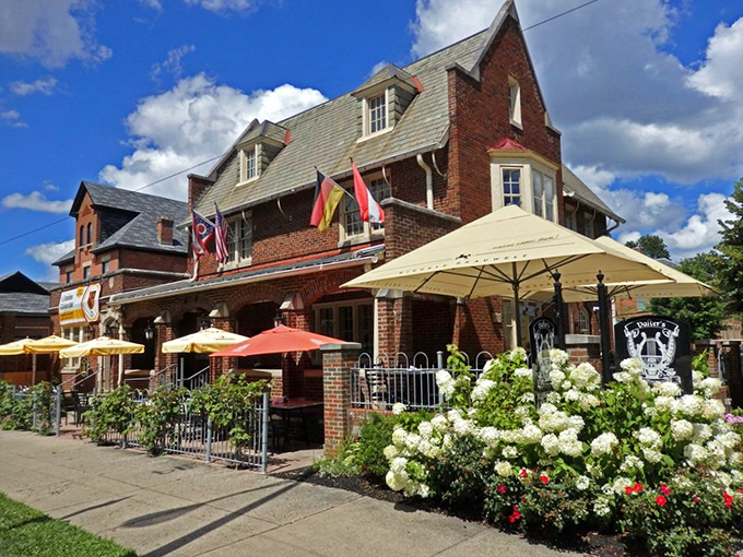 The stately brick exterior of Valter's welcomes visitors with colorful umbrellas, international flags, and blooming hydrangeas&mdash;Germany meets Midwest in architectural harmony.