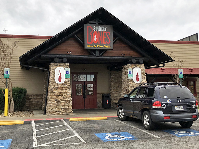 The rustic lodge-style exterior of Smokey Bones beckons like a carnivore's lighthouse in a sea of suburban shopping centers.