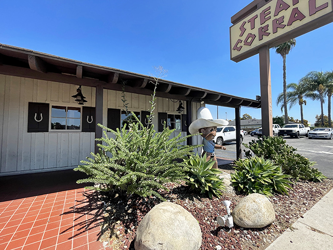 The unassuming exterior of Steak Corral stands like a time capsule of classic California dining, complete with longhorn skull and vintage signage.