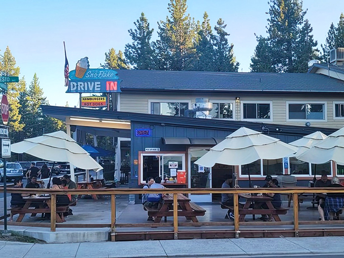 The iconic turquoise-blue Sno-Flake Drive-In stands proudly against Tahoe's pine backdrop, its vintage sign promising burgers and nostalgia in equal measure.