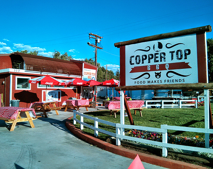 The iconic red building with its black pig logo stands as a beacon of barbecue excellence against the stunning Eastern Sierra backdrop.