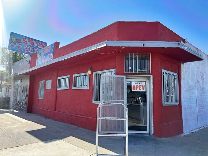The unassuming corner building in red and green announces itself with no pretense—just the quiet confidence of a place that knows its birria speaks volumes.