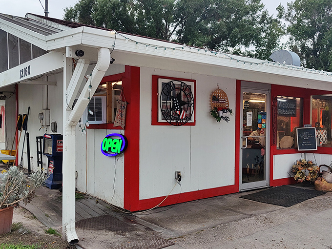 The iconic red-trimmed exterior of Red Top Pit Stop stands like a beacon for hungry travelers. This unassuming roadside gem promises comfort food paradise within. 