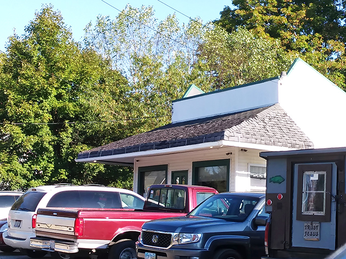 The humble white exterior with teal trim might not scream "culinary destination," but locals know this unassuming building houses flavor treasures worth the drive.