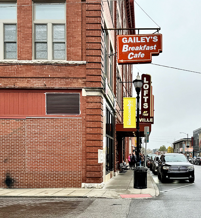 The iconic orange Gailey's sign beckons breakfast enthusiasts like a beacon of hope on Springfield's historic brick landscape. Morning salvation awaits inside!