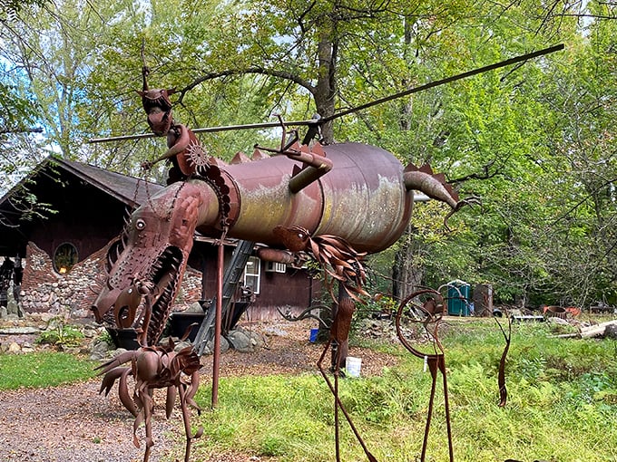 The guardian dragon of Jurustic Park seems ready to take flight among the trees, its metallic scales gleaming like ancient armor in the Wisconsin sunlight.