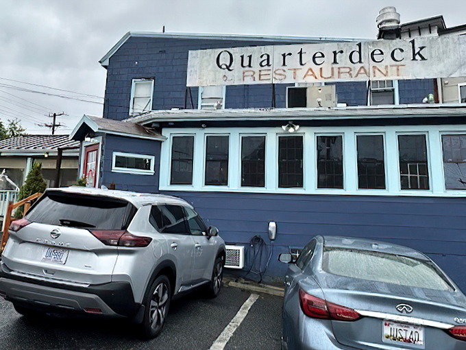 The navy blue exterior of Quarterdeck glows at dusk, a beacon for crab lovers hiding in plain sight along Arlington's streets.