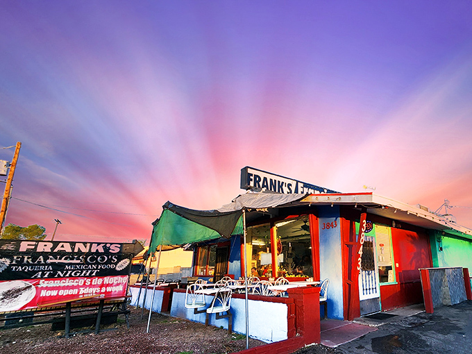 The vibrant red and blue exterior of Frank's/Francisco's stands like a colorful oasis in Tucson, promising authentic Mexican flavors behind that unassuming blue door.