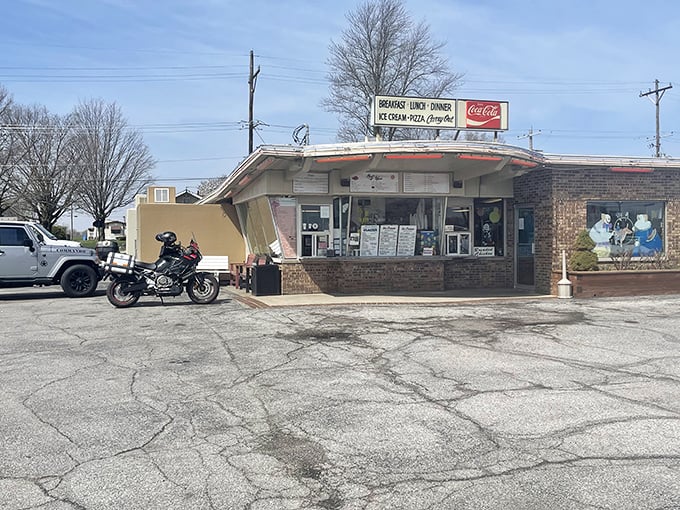 The classic mid-century curved roof of Magic Wand beckons like a time machine disguised as a restaurant. Those red Coca-Cola umbrellas aren't just for show&mdash;they're portals to simpler times.