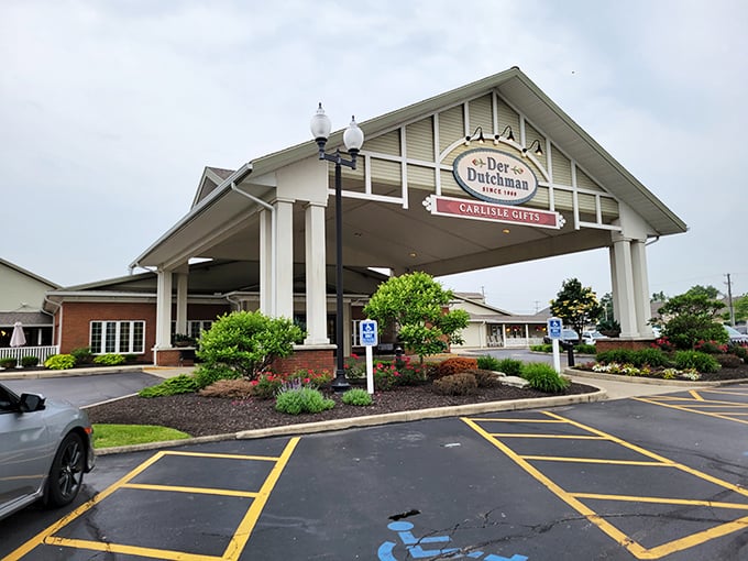 The welcoming entrance to Der Dutchman stands like a culinary lighthouse, beckoning hungry travelers with promises of Amish comfort food that'll make your cardiologist wince and your soul sing.