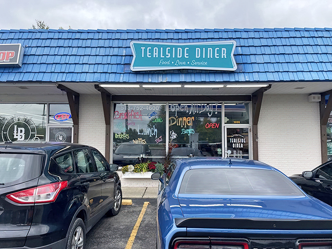 The blue roof of Tealside Diner stands out like a beacon of breakfast hope. This unassuming strip mall gem promises culinary treasures within.
