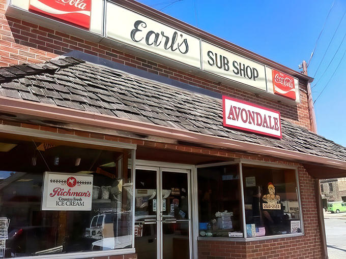 The brick façade of Earl's Sub Shop stands as a timeless monument to sandwich perfection, beckoning hungry travelers with its classic Coca-Cola signage and small-town charm.