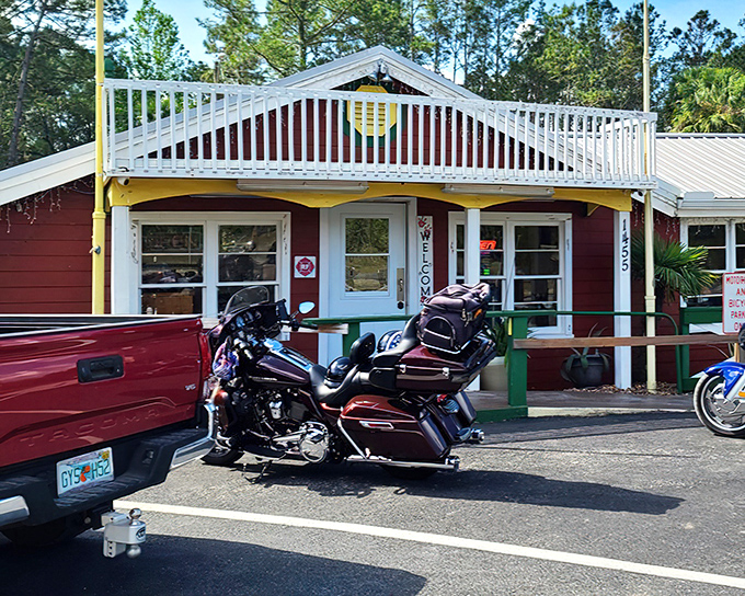 The burgundy exterior with white railings beckons like an old friend, promising comfort food and conversations that flow as easily as the coffee.
