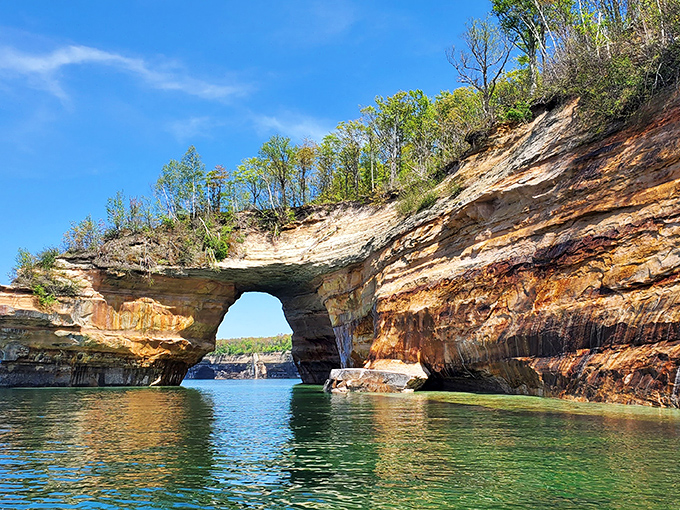 Nature's own stone archway, Lovers Leap stands as a testament to Lake Superior's patient artistry, framing the turquoise waters beyond like a living postcard.