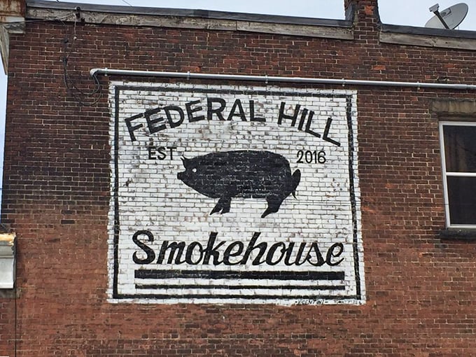 The unassuming brick exterior of Federal Hill Smokehouse stands like a barbecue beacon in Erie, complete with picnic tables where smoke-scented dreams come true.