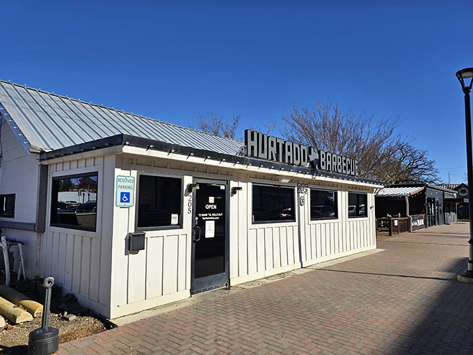 The unassuming white exterior of Hurtado Barbecue proves once again that in Texas, the most spectacular barbecue often hides in plain sight.