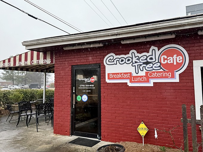 The bright red exterior of Crooked Tree Cafe beckons like a culinary lighthouse, promising breakfast salvation to weary morning travelers.