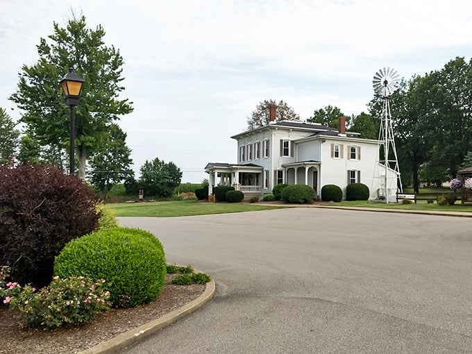 The iconic white barn structure sits majestically beside a serene pond, where ducks seem to know they've chosen the best neighborhood restaurant.