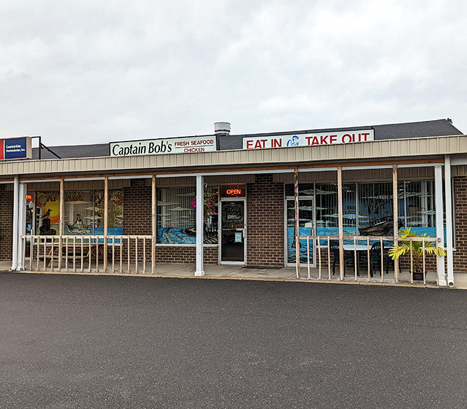 The unassuming exterior of Captain Bob's belies the seafood treasures within. Strip mall location, maritime signage, and the promise of both eat-in and take-out options.