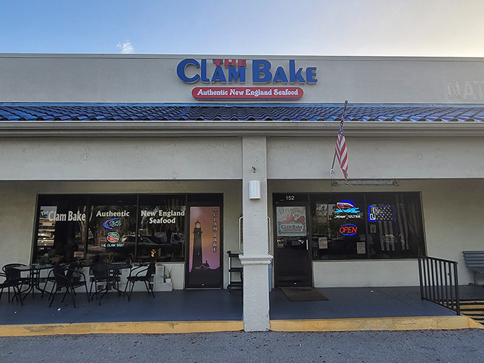 The blue-roofed beacon of The Clam Bake stands out against Florida's sunny skies, promising New England seafood treasures within its unassuming exterior.