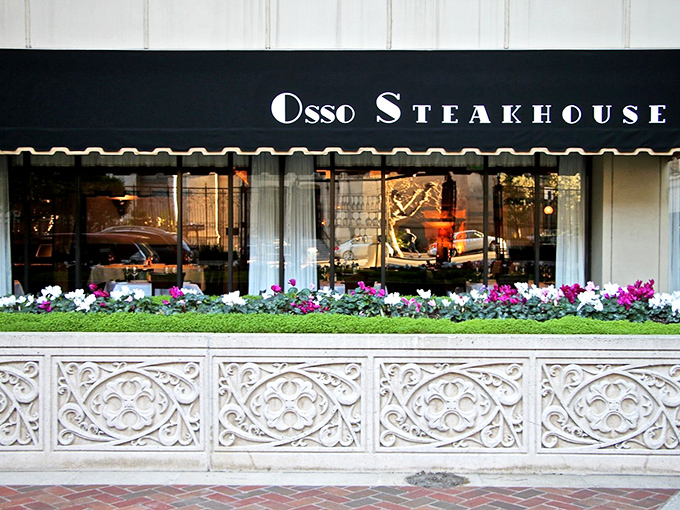 Elegance announces itself quietly on Nob Hill, where Osso Steakhouse's classic black awning and vibrant flower boxes promise sophisticated delights within.