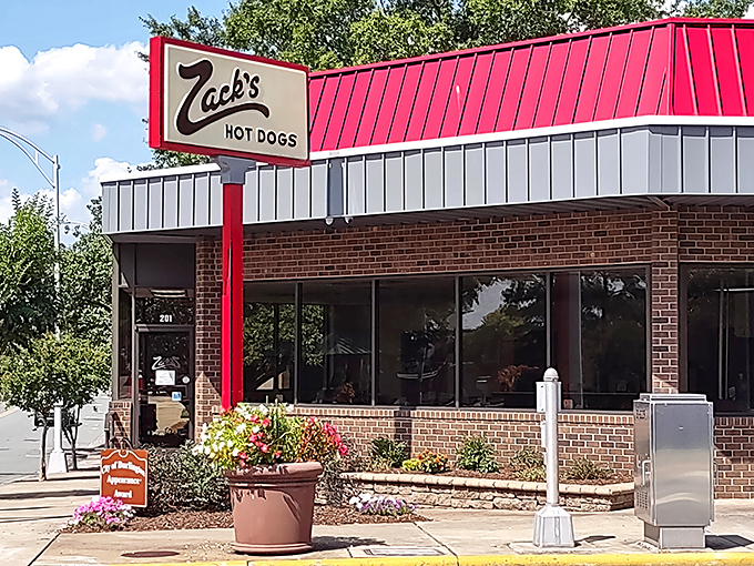 That red and white exterior isn't just signage – it's a beacon calling hungry souls to hot dog heaven.
