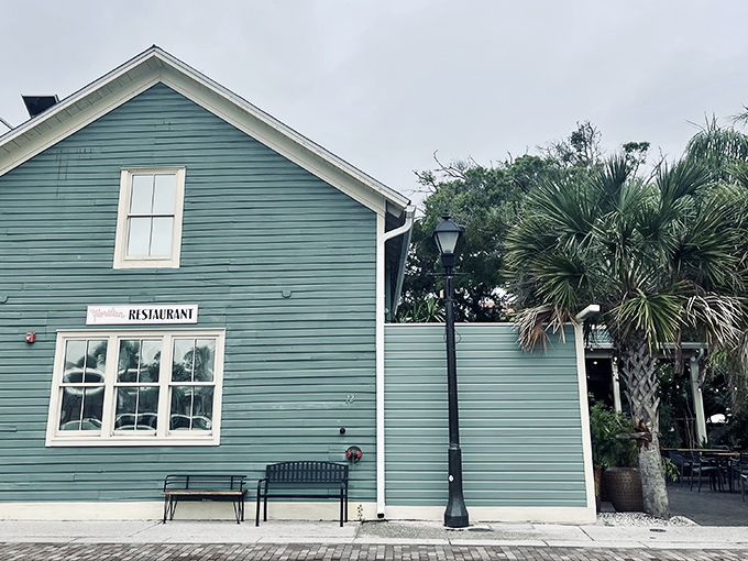 The seafoam-green exterior of The Floridian stands like a culinary lighthouse in St. Augustine's historic district, beckoning hungry travelers with Southern charm.