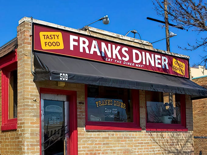 That red brick facade with the striped awning whispers "authentic diner magic" before you even step inside.