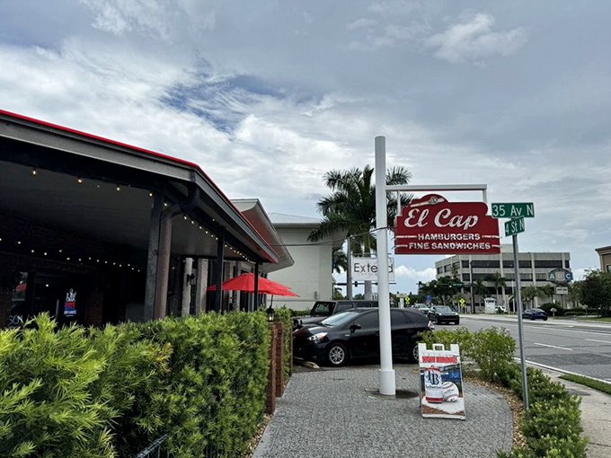 The classic red sign beckons like an old friend on 4th Street North. No pretense, just the promise of legendary burgers waiting inside.