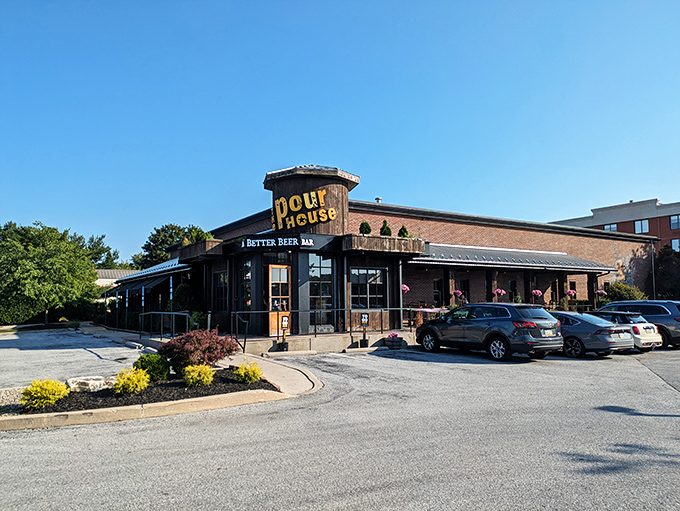 The Pour House stands like a rustic beacon of culinary promise, its wooden facade and octagonal entrance saying "yes, the food inside is as characterful as our architecture."