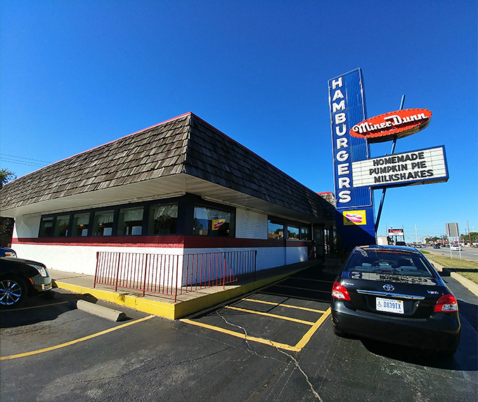 That iconic A-frame roof and vintage neon sign aren't just restaurant architecture—they're a time portal to when burgers were simple and simply perfect.