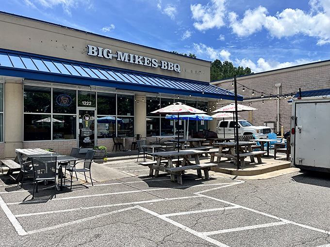 Blue awnings and picnic tables welcome you to this unassuming strip mall treasure where smoke signals announce serious barbecue business is happening inside.