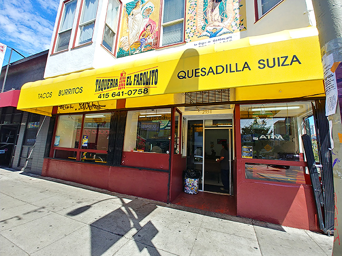 The iconic yellow awning of El Farolito stands out like a beacon of burrito hope, complete with colorful murals that set the perfect stage.