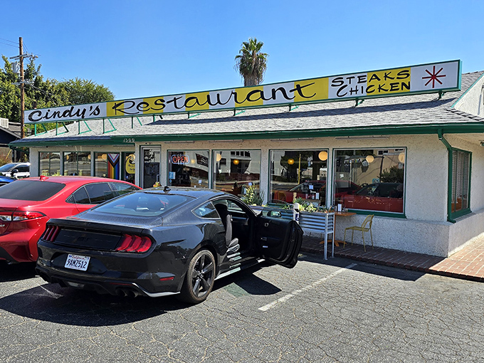 The iconic yellow and green sign of Cindy's Restaurant stands as a beacon of breakfast hope in Eagle Rock, promising steaks, chicken, and retro charm.