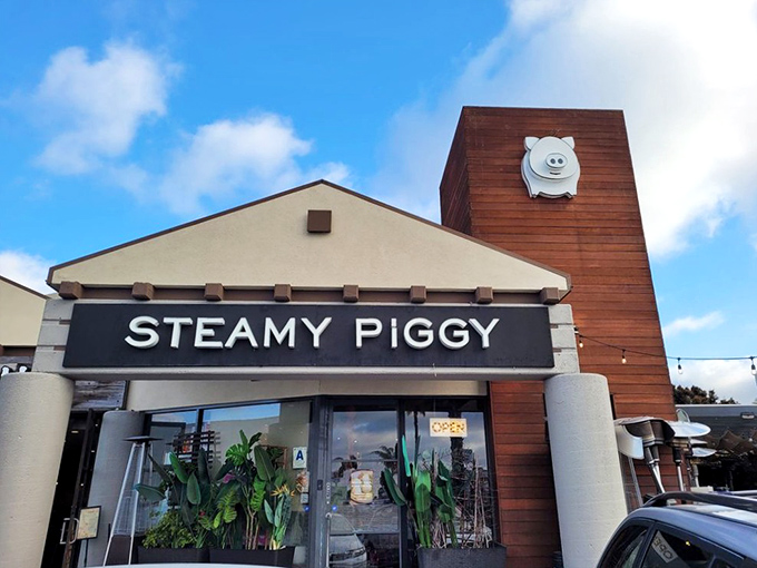 Steamy Piggy's exterior combines modern architecture with playful charm. That smiling piggy logo isn't just cute—it's a beacon calling hungry souls to dumpling paradise.