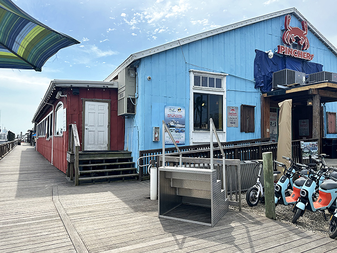 Pinchers' cheerful blue exterior beckons seafood lovers like a coastal lighthouse, promising treasures from the deep just steps from the water.