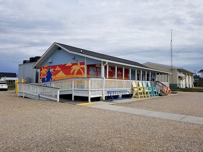 LongBill's cheerful blue exterior with its vibrant sunset mural practically screams "vacation mode activated!" The colorful Adirondack chairs are just waiting for you.