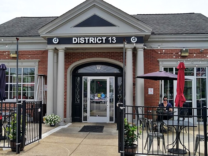 The architectural equivalent of a firm handshake &ndash; District 13's brick exterior with white columns promises small-town charm with big-city flavors waiting inside.