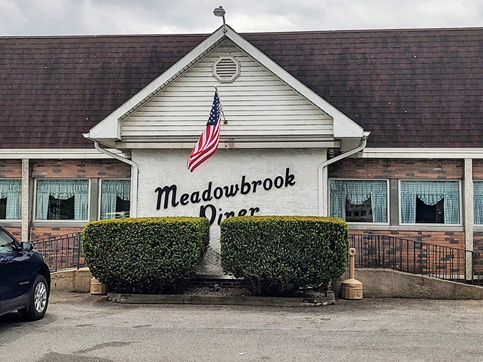 The classic American flag above Meadowbrook Diner isn't just decoration&mdash;it's a promise that inside awaits the kind of breakfast that made this country great.
