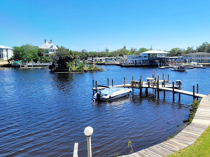 Where the sky meets the water in perfect Florida harmony. Palm trees stand like nature's welcome committee along this peaceful riverfront paradise.
