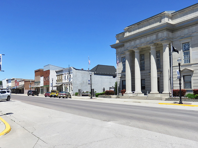 The stately courthouse stands like a proud parent watching over Main Street, its columns a reminder that small-town America still knows how to make an architectural statement.