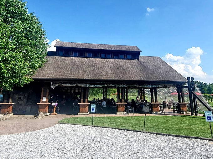 The rustic barn exterior of Sarah's Vineyard welcomes visitors with its weathered wood charm and inviting outdoor seating&mdash;Napa Valley spirit with heartland hospitality.
