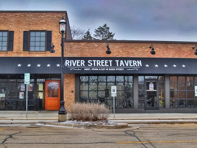 The unassuming brick exterior of River Street Tavern hides culinary treasures like a poker player concealing a royal flush. That orange door practically beckons you inside.