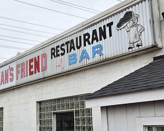 The unassuming exterior of The Workingman's Friend stands as a beacon to burger pilgrims, its vintage sign promising honest food and cold drinks.