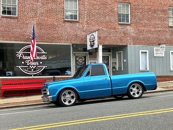 Classic Americana at its finest – a vintage blue pickup parked outside the brick-fronted Franklinville Diner, where time slows down and appetites ramp up.