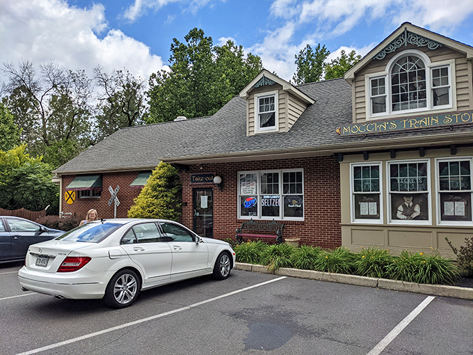 Moccia's Train Stop welcomes hungry travelers with its charming brick-and-siding exterior, complete with railroad crossing signs that hint at culinary journeys ahead.