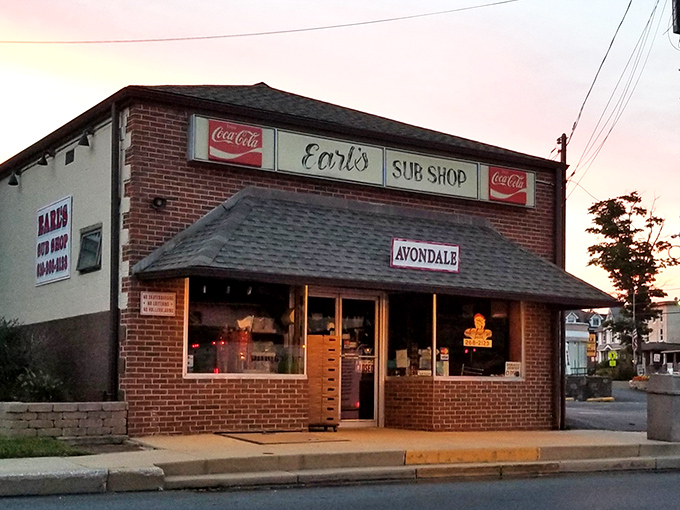 The brick fa&ccedil;ade of Earl's Sub Shop stands as a timeless monument to sandwich perfection, beckoning hungry travelers with its classic Coca-Cola signage and small-town charm.